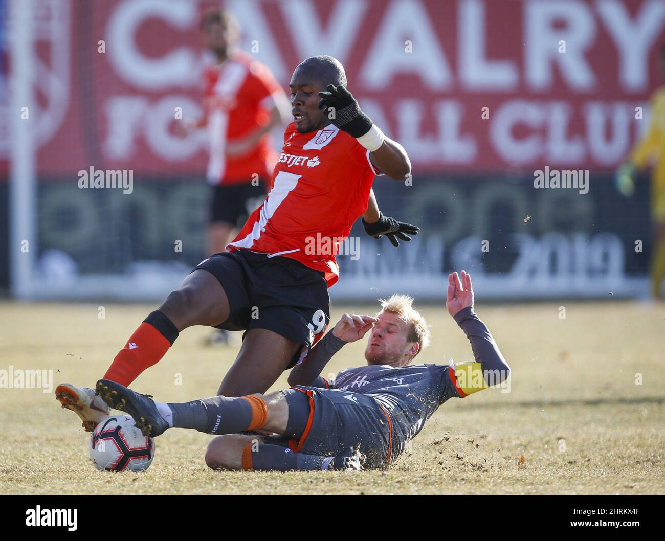 Hamilton Forge's Kyle Bekker, right, falls beside Calgary Cavalry's ...