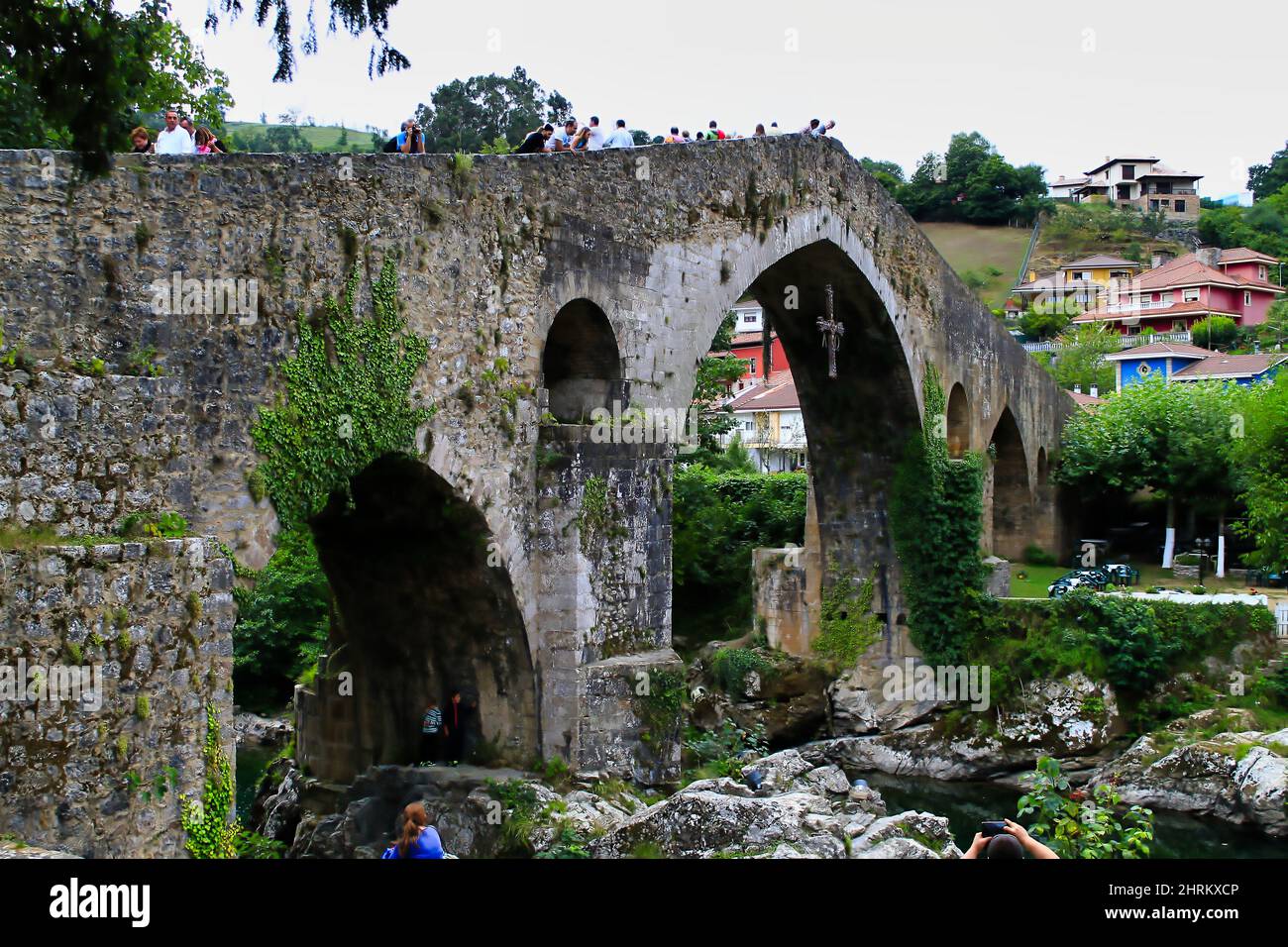 Old Roman stone bridge over the river seals and surrounded by greenery ...