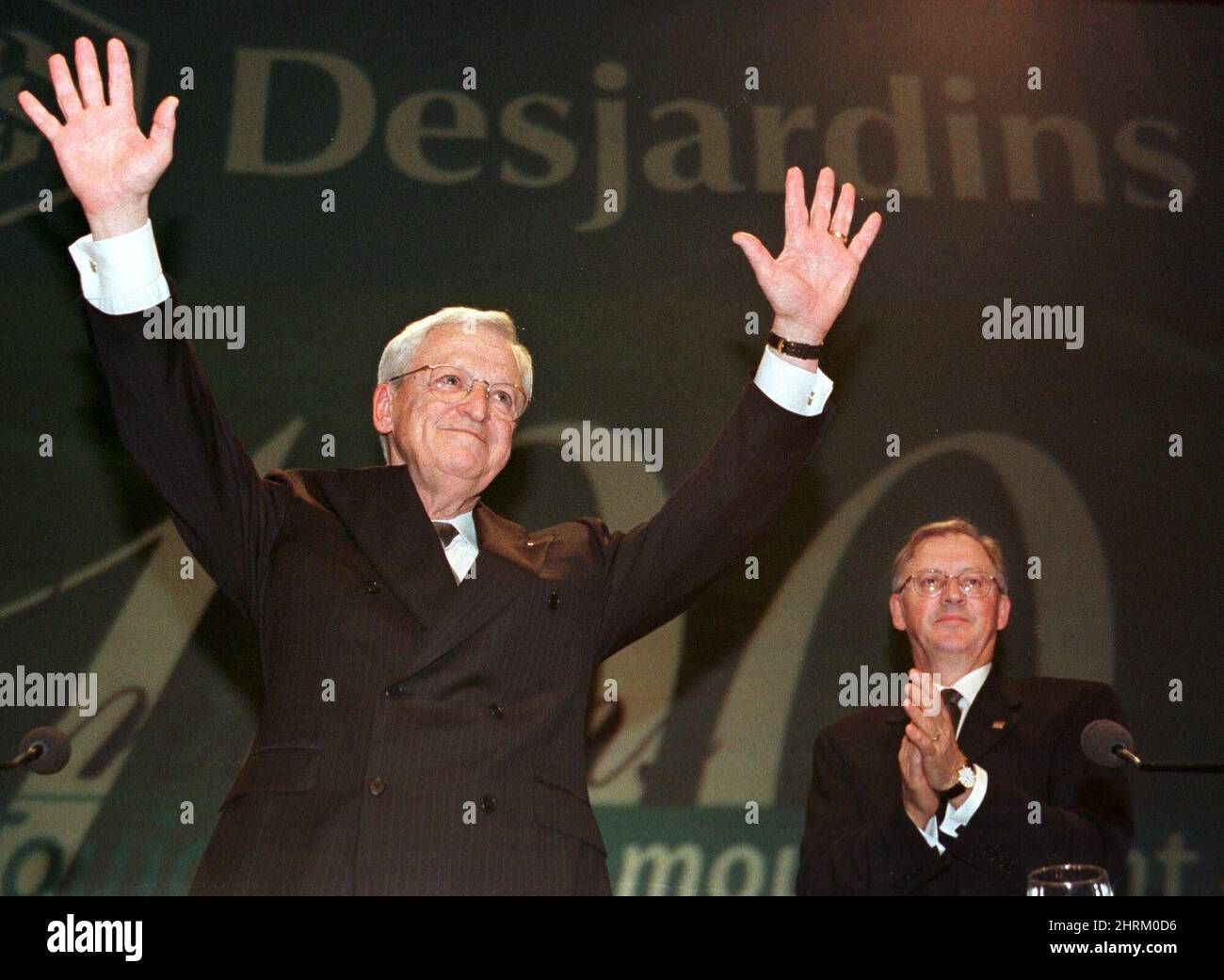 Desjardins president Claude Beland, waves to delegates following his ...