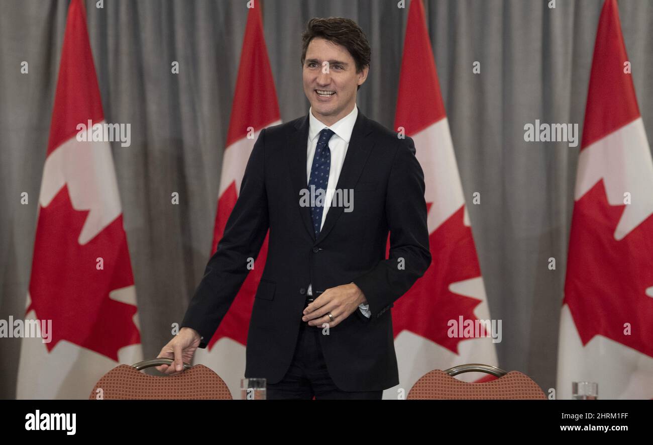 Prime Minister Justin Trudeau takes his seat at the start of a meeting ...
