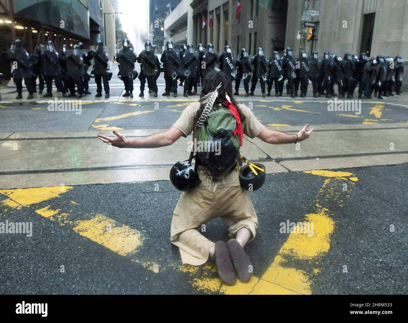 A protester reacts to the riot police while marching along the streets ...