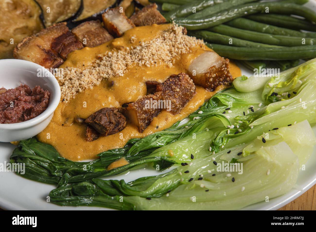Closeup shot of crispy kare, pork belly in sauce with peanuts and ...