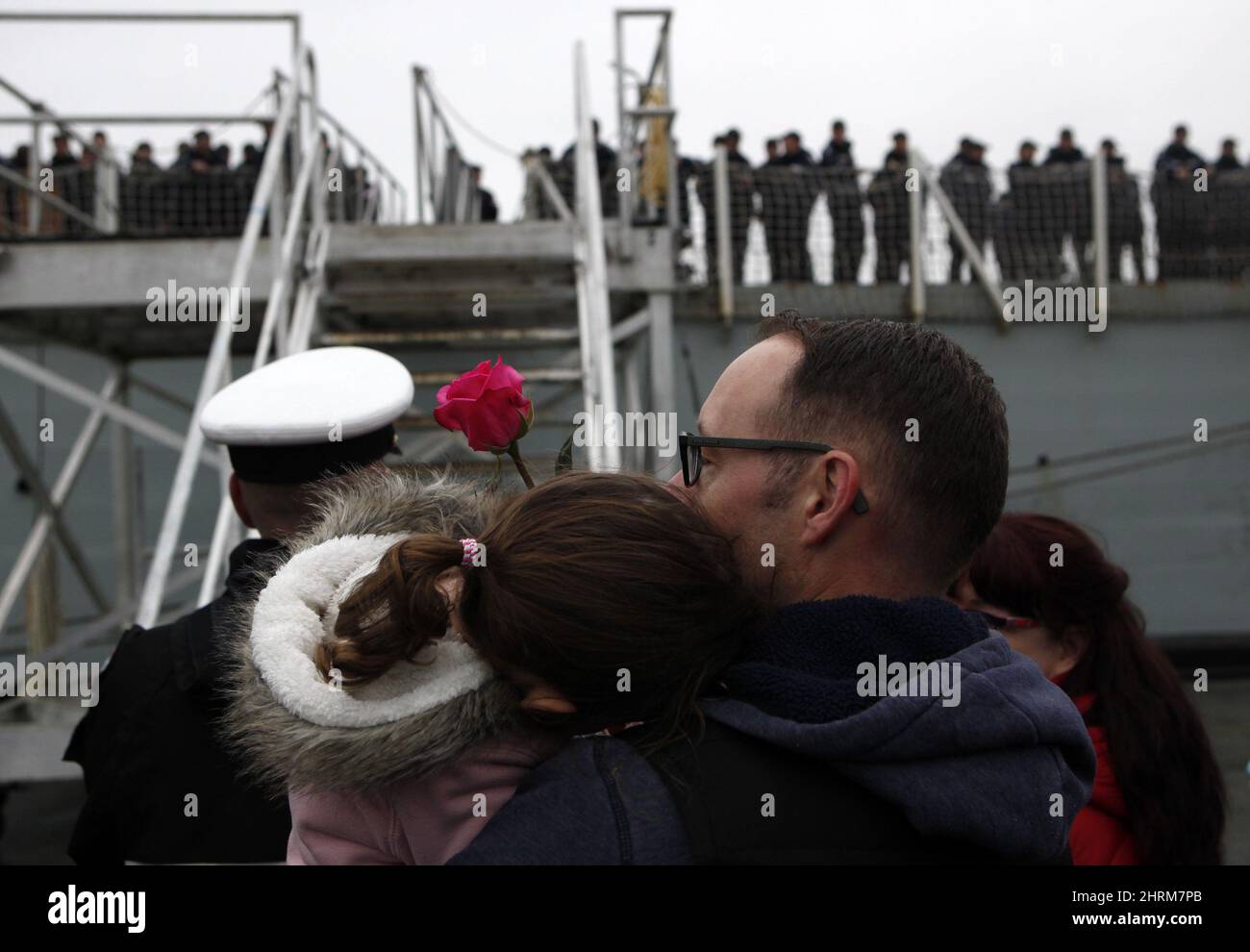 Leading Seaman Evan Lawrence, right, and his daughter Emily, 3, wait on ...