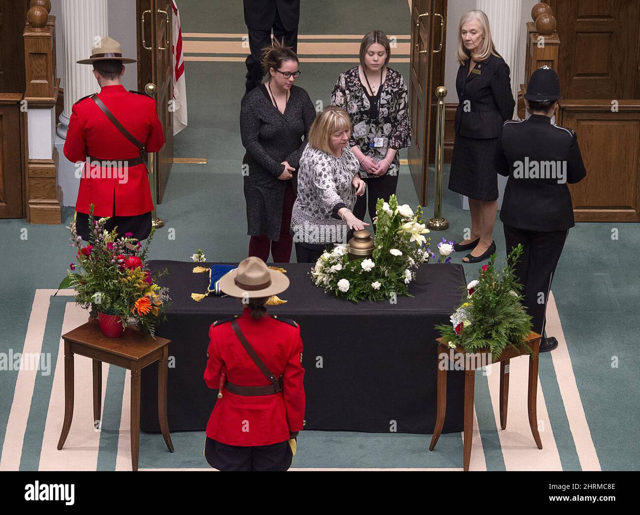 A woman touches the urn containing the ashes of John Crosbie, a former ...