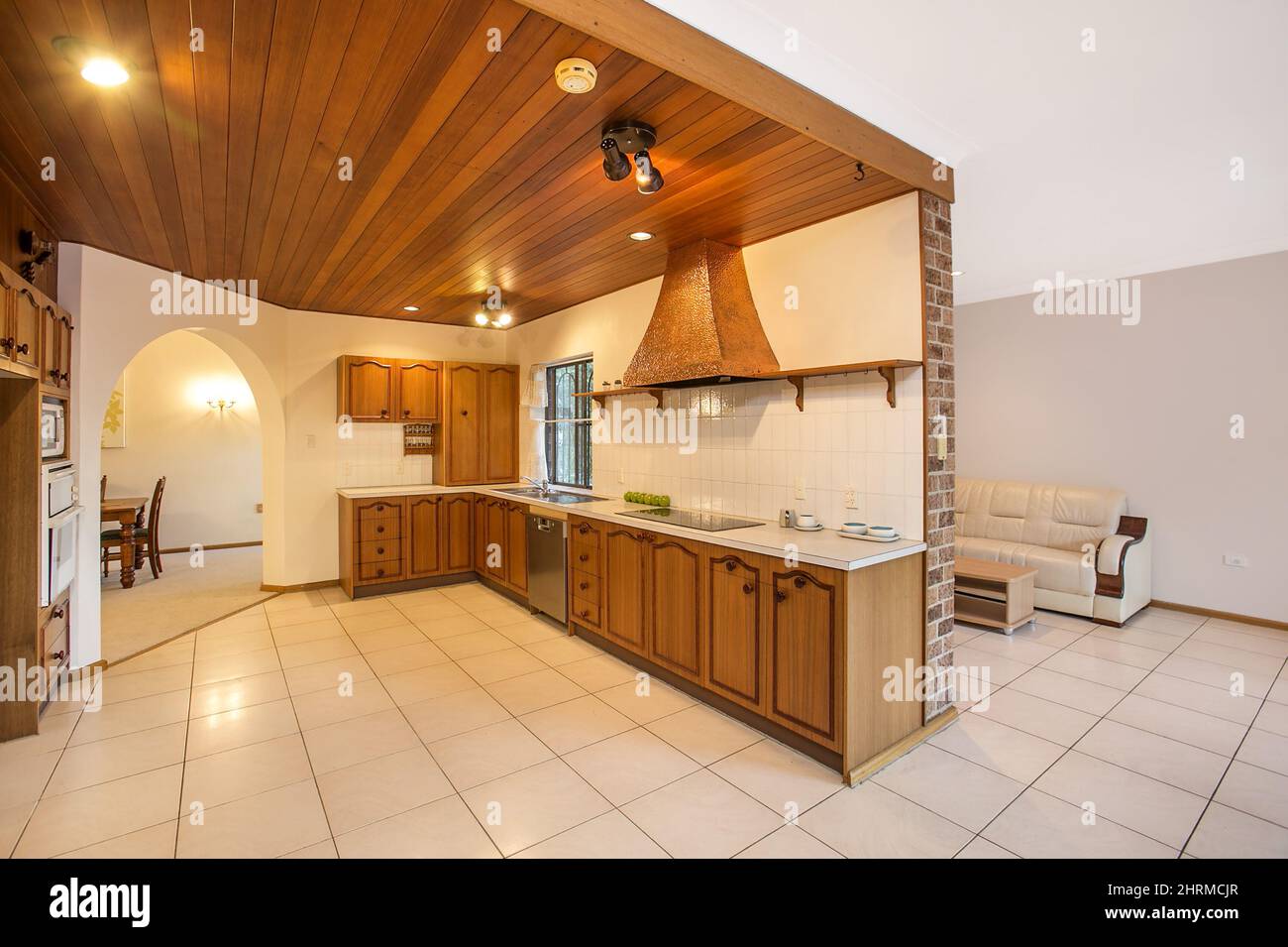 Large kitchen interior with wooden furniture and ceiling Stock Photo ...