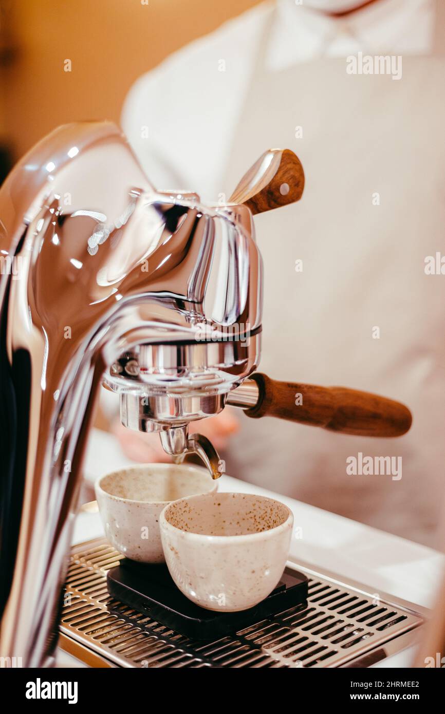Shallow focus of a male hand preparing a cup for grounded coffee with a coffee machine Stock ...