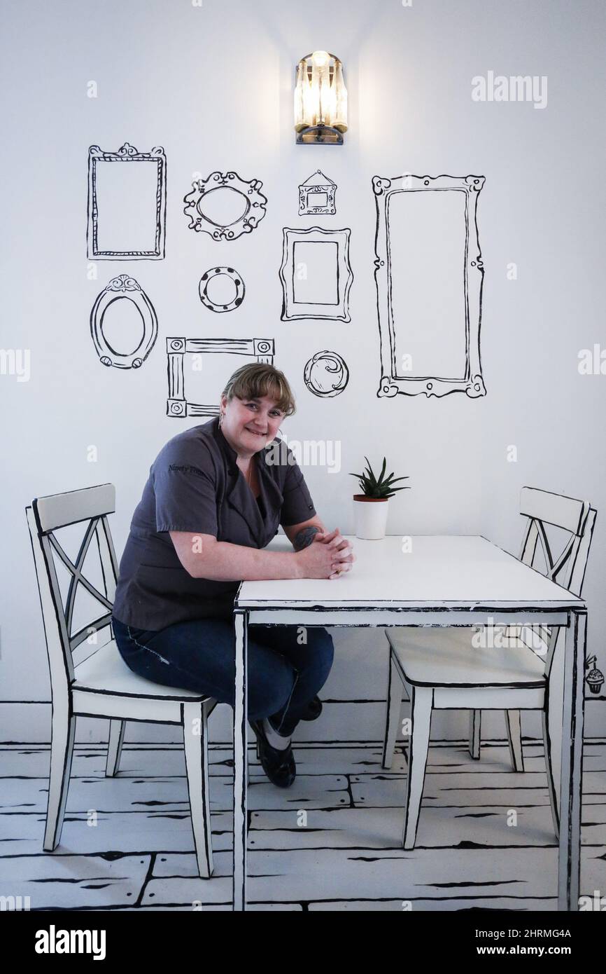 Customers at the 94 Take the Cake cafe and bakery enjoy a "2D ...