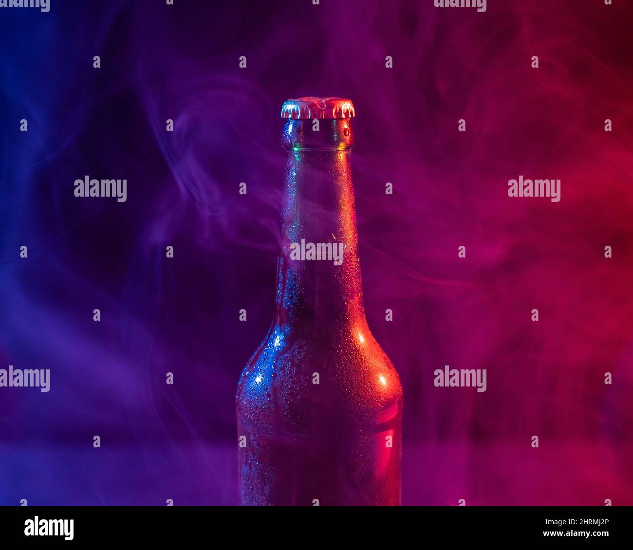 Glass bottle of beer in blue pink mist Stock Photo - Alamy