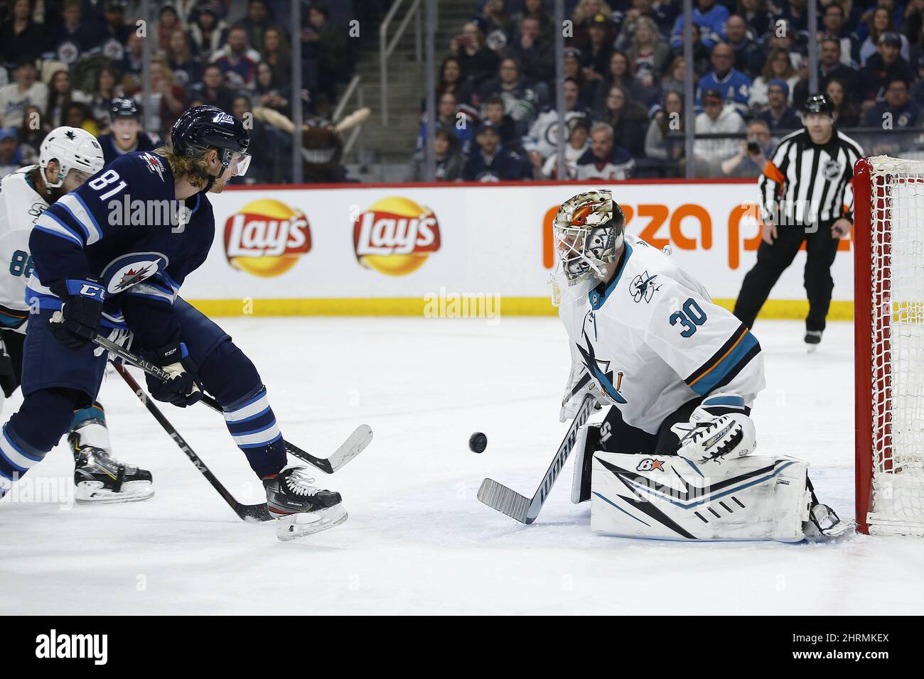 Winnipeg Jets' Kyle Connor (81) takes the shot through his legs and ...