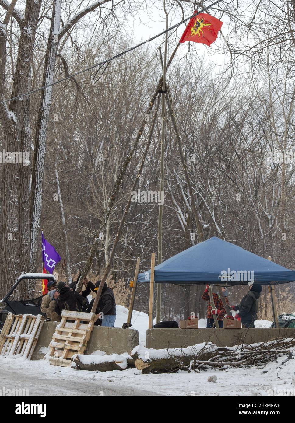 Members of the Mohawk community raise the Mohawk flag at the entrance ...