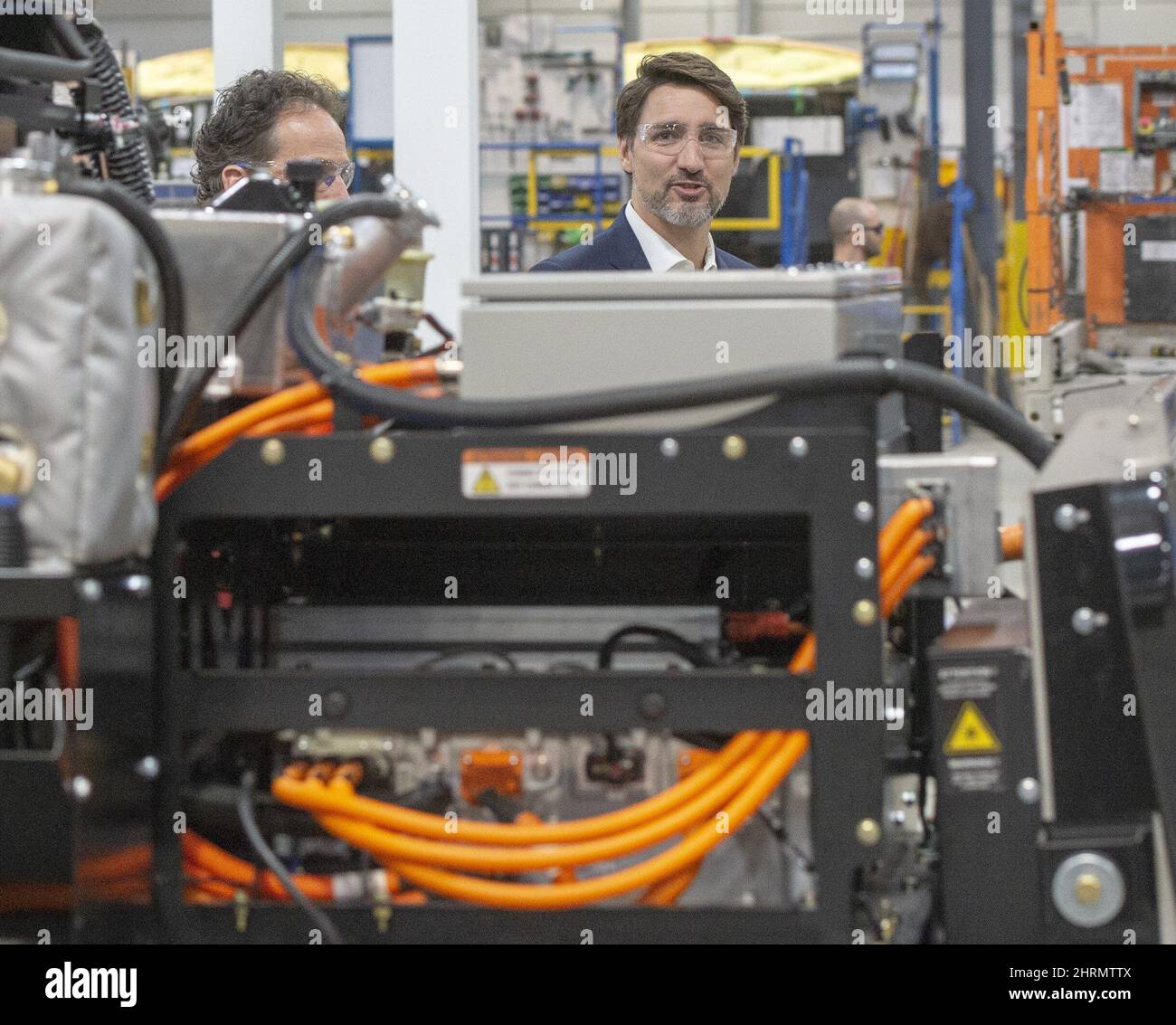Prime Minister Justin Trudeau looks at the motor of an electric bus ...