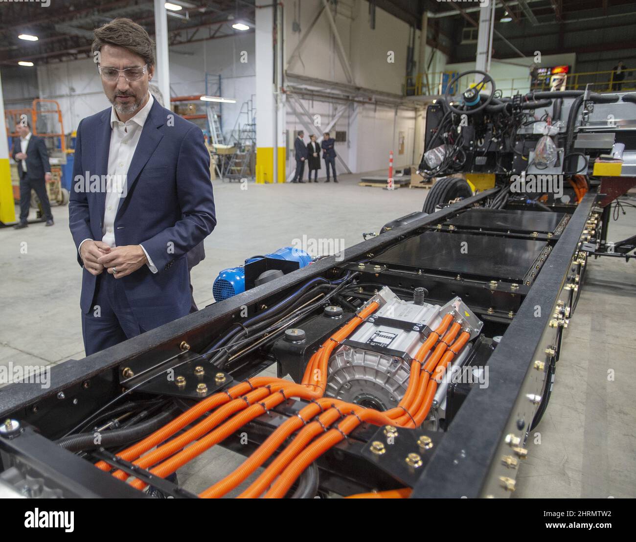 Prime Minister Justin Trudeau looks at the frame of an electric bus ...