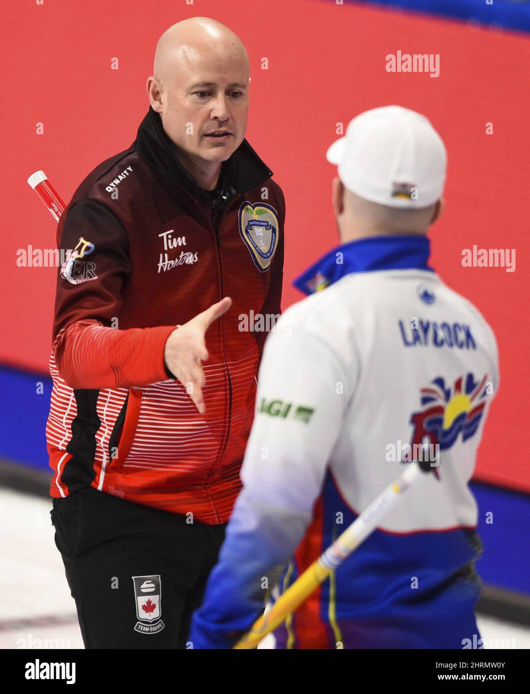 Team Canada skip Kevin Koe shakes hands with Team BC skip Steve Laycock ...