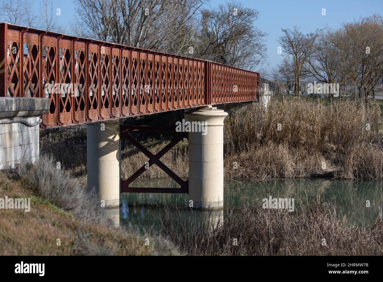Selective focus shot of the side rails of a bridge over a river with ...