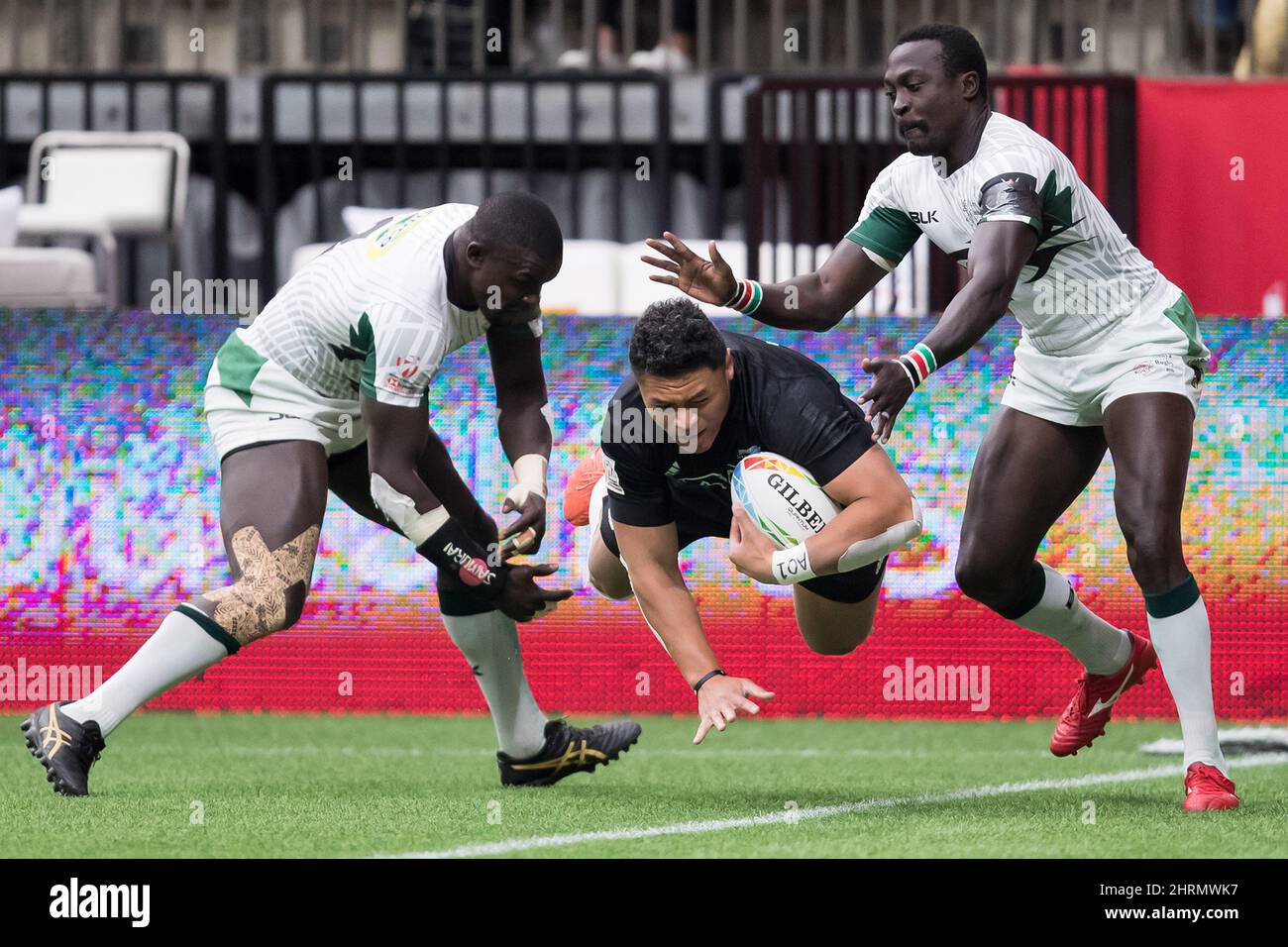 New Zealand's Caleb Clarke, centre, scores a try against Kenya's Andrew ...