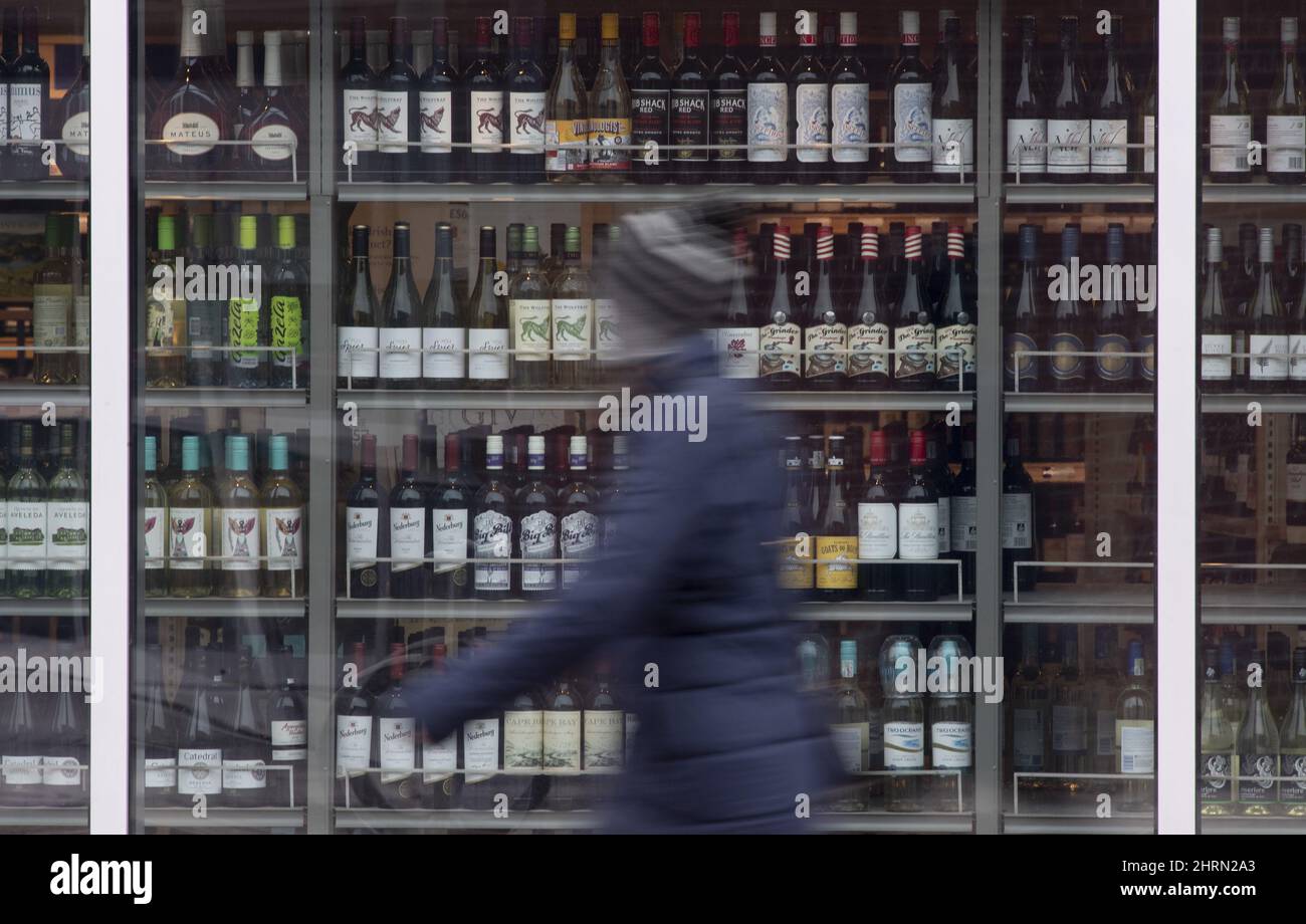 A person walks past shelves of bottles of alcohol on display at an LCBO ...