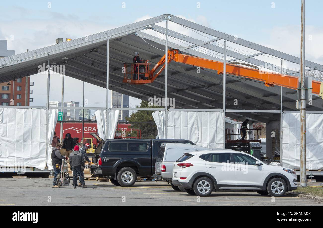Workers put up a tent for overflow patients outside the Verdun Hospital ...