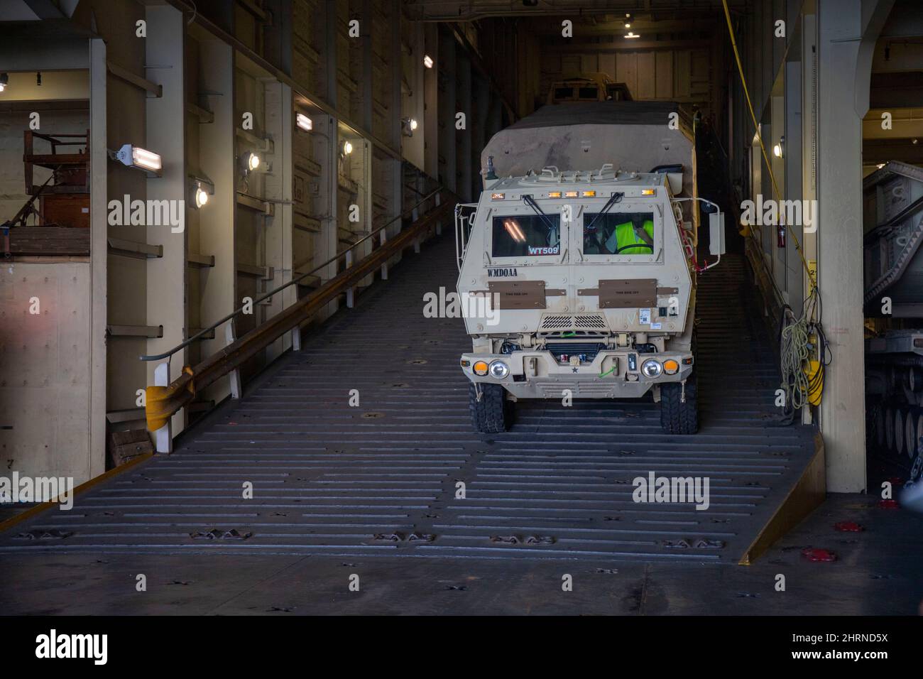 A vehicle aboard the U.S. Naval Ship Red Cloud is driven off the vessel ...