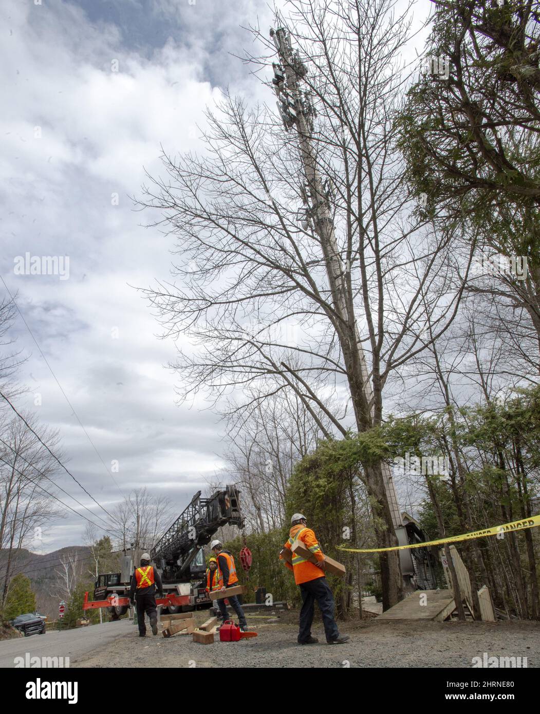 Technicians repair a cell tower after a fire that police are calling ...