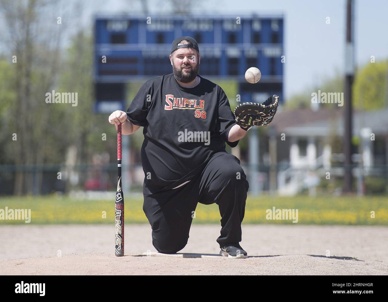Jason Dorrington, who is a member of 'The Shuffle' softball team, poses ...