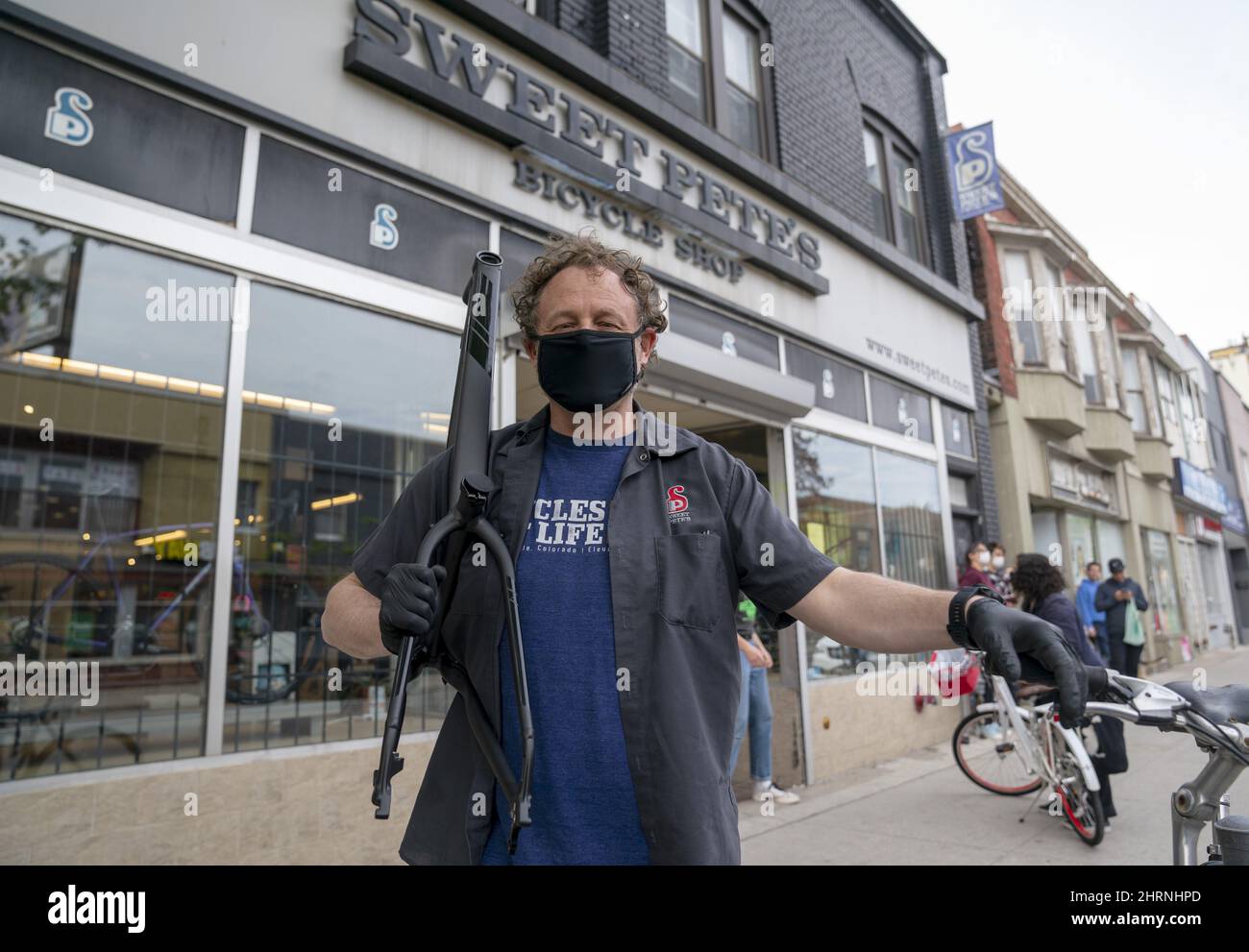 Pete Lilly of Sweet Pete's Bike Shop poses in front of his store in ...