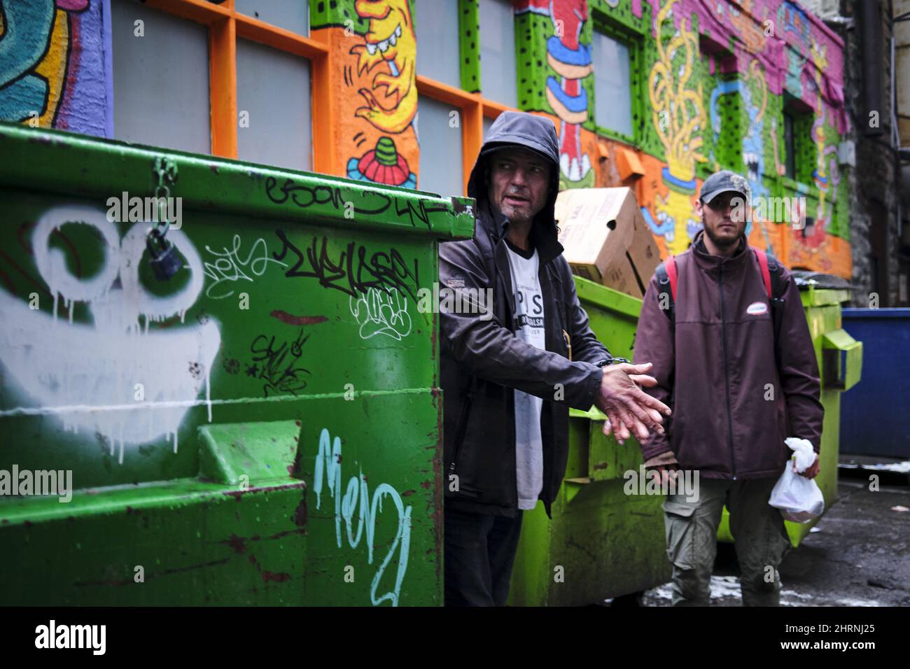 Gordon Kelter, left, who is homeless, uses hand sanitizer in Calgary ...