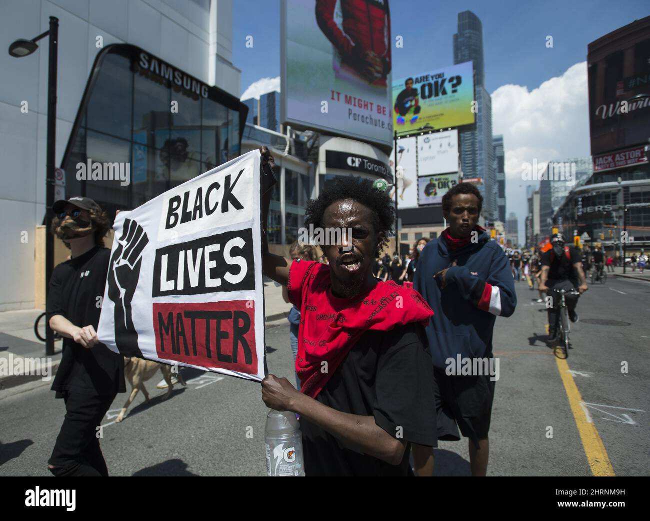 People hold up a sign as thousands of people protest at an anti-racism ...