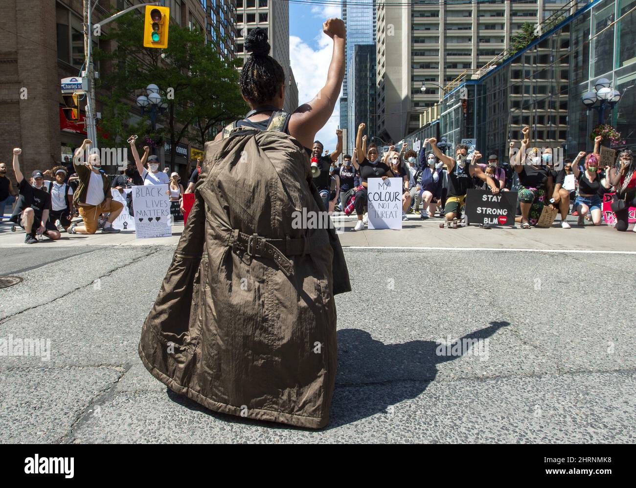Anti-racism demonstrators take a knee near Toronto Police Headquarters ...