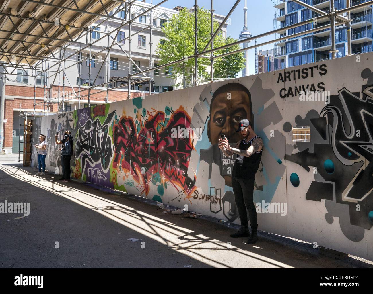 People take photographs of new graffiti art in Graffiti Alley in ...