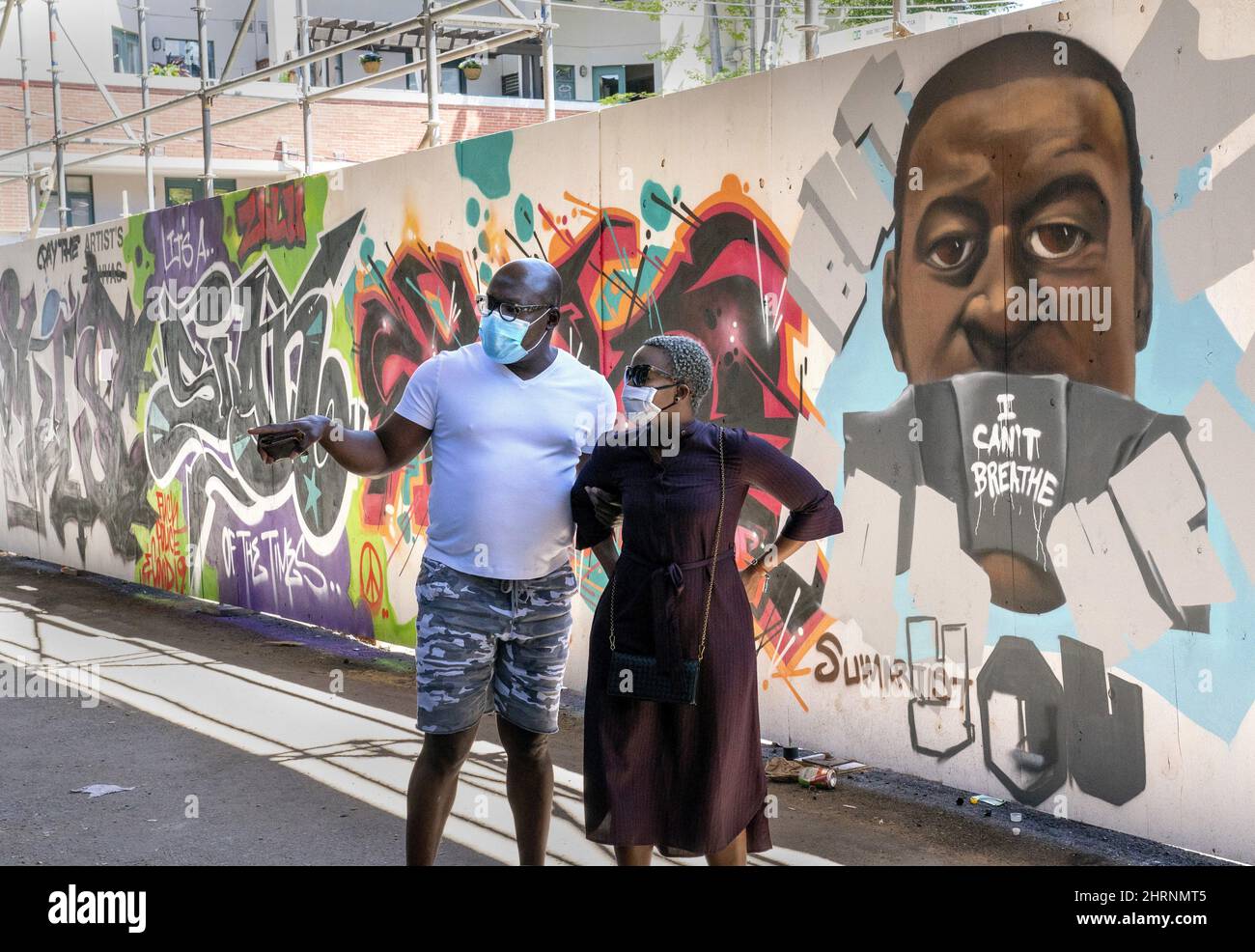 A man and woman admire new graffiti art in Graffiti Alley in Toronto on ...