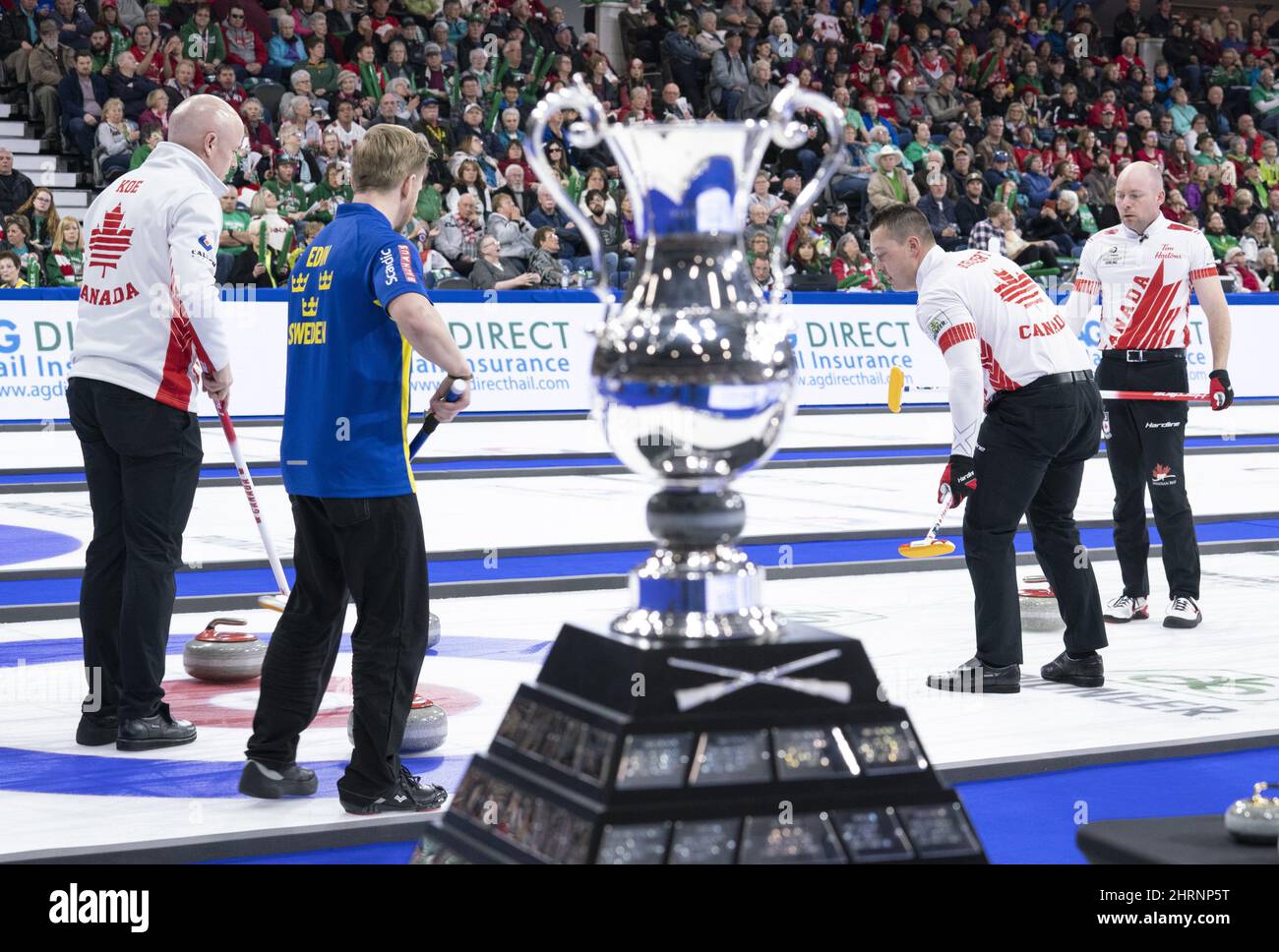 Canada skip Kevin Koe and Sweden skip Niklas Edin watch a shot come in ...