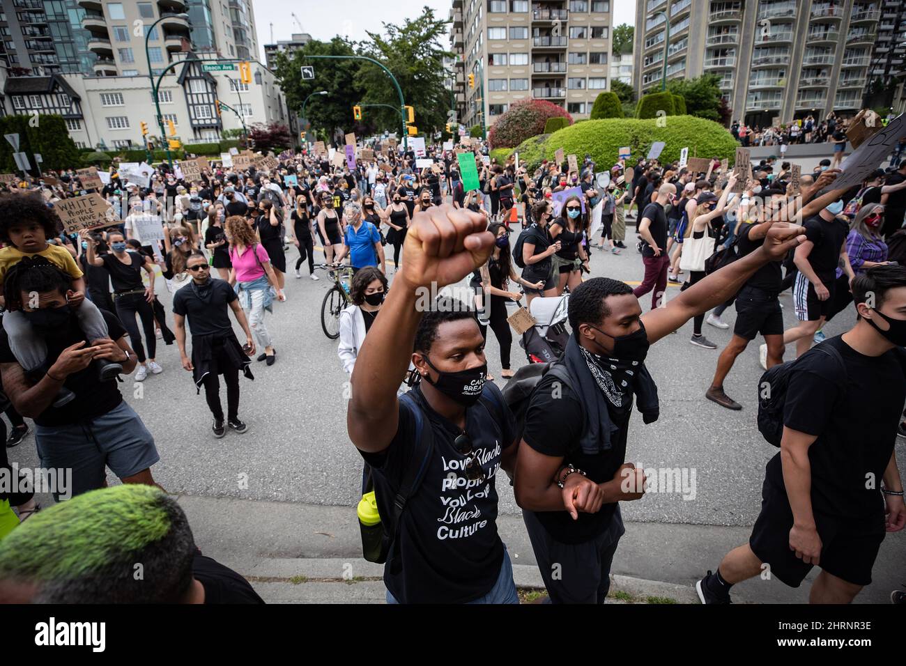 Two men walk with their arms linked together and fists in the air as ...