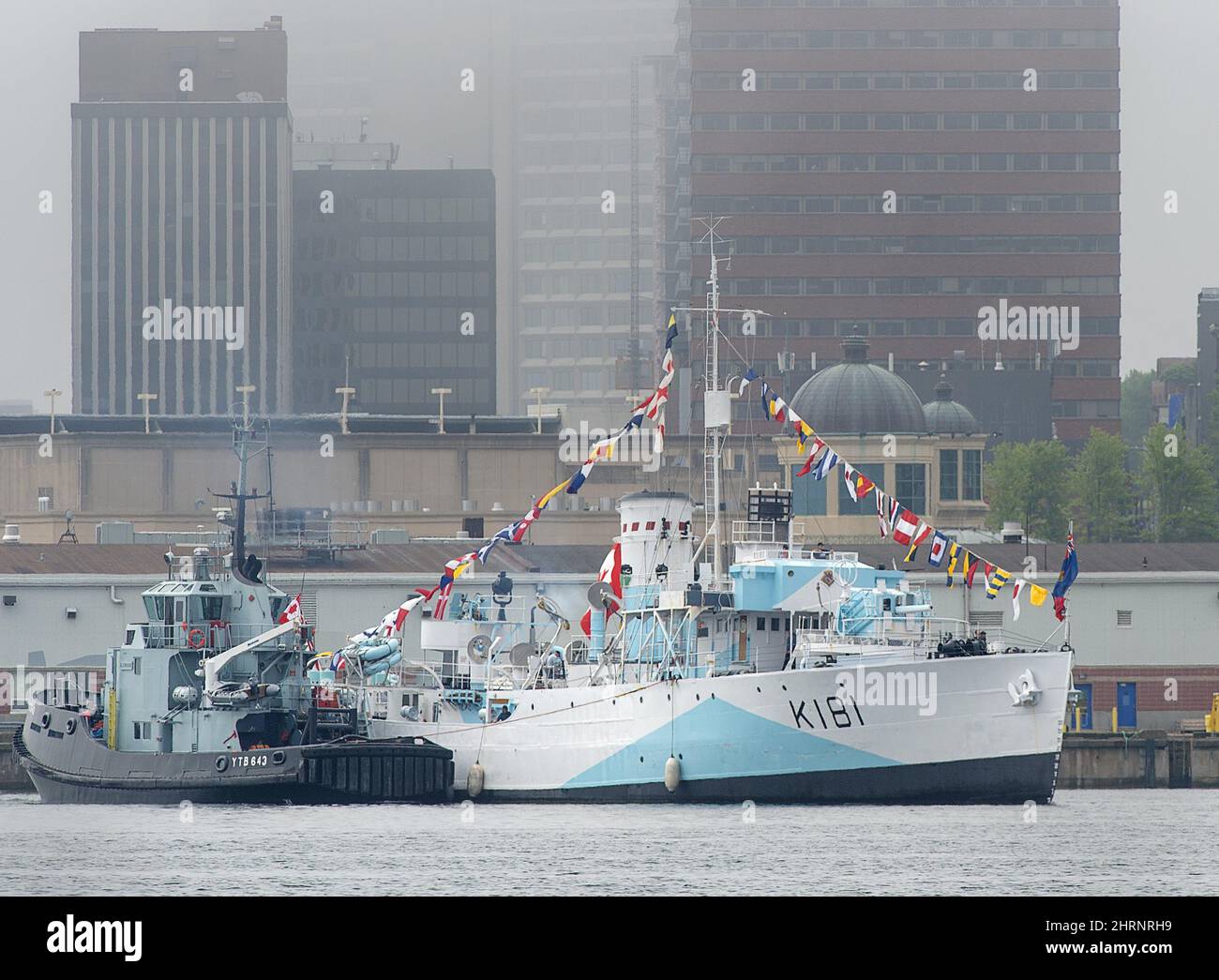 HMCS Sackville, a Flower-class corvette, with the help of a navy tug ...