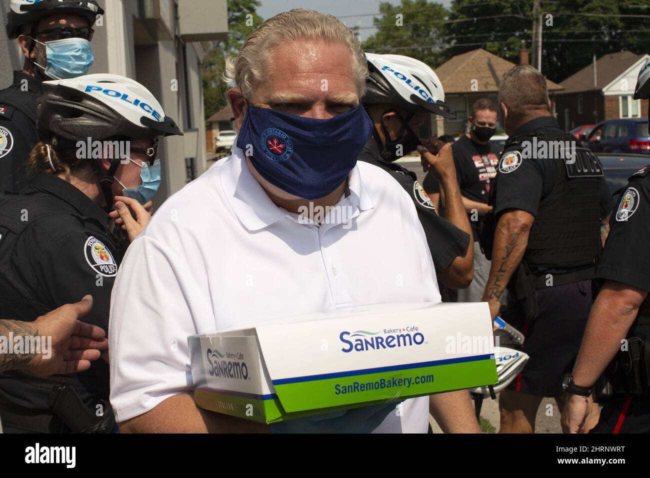 Ontario Premier Doug Ford holds a box of pastries after visiting a ...