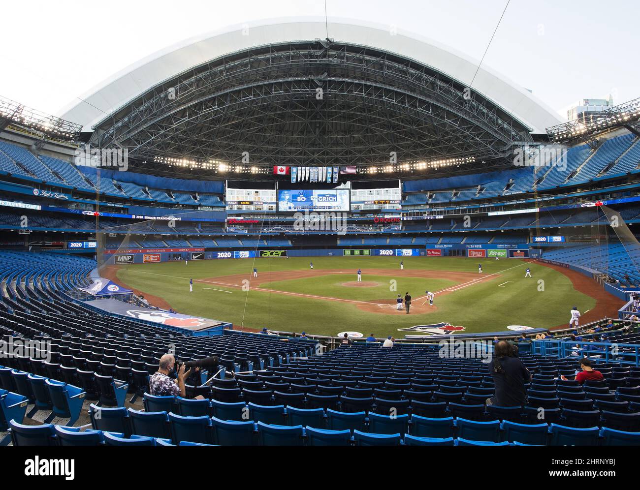 Photographers cover the game in an empty stadium during fourth inning ...