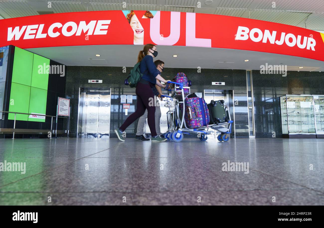 Passengers walk through Montreal-Trudeau International Airport in ...