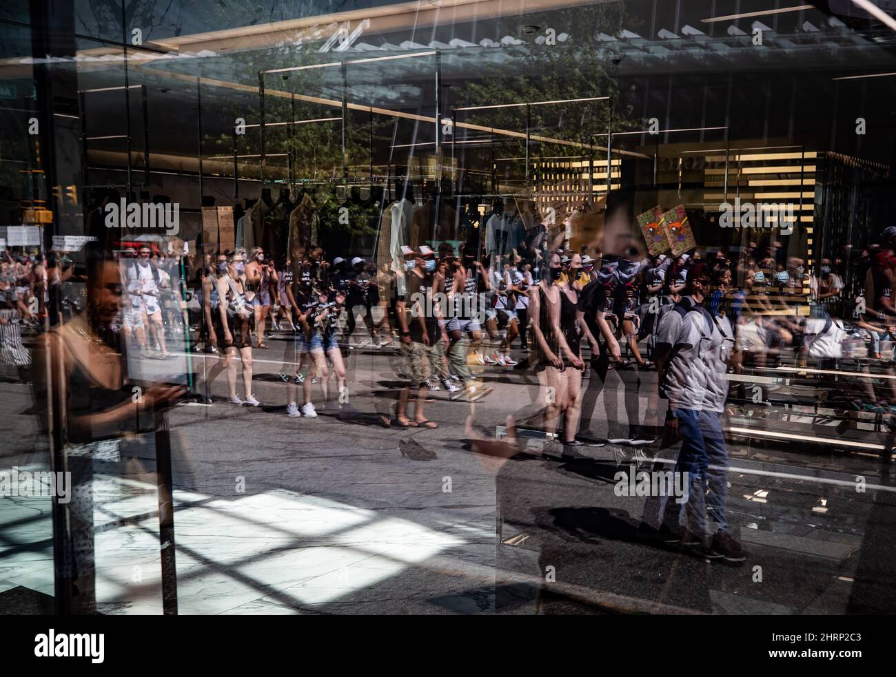 People participating in an Emancipation Day March are reflected in the ...