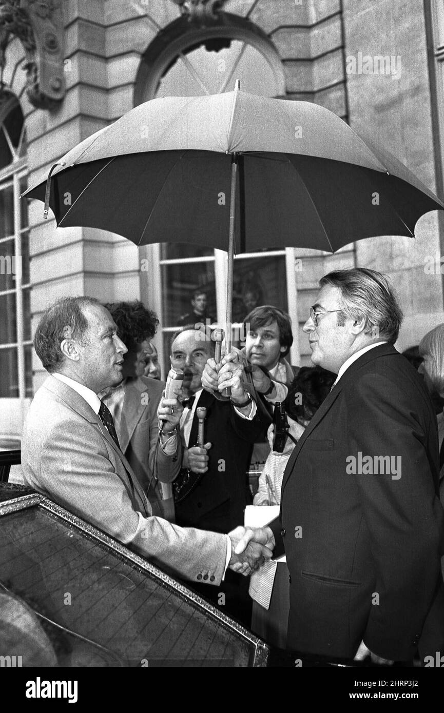 Broadcast News reporter Peter Ray (back centre, right) covers a meeting ...