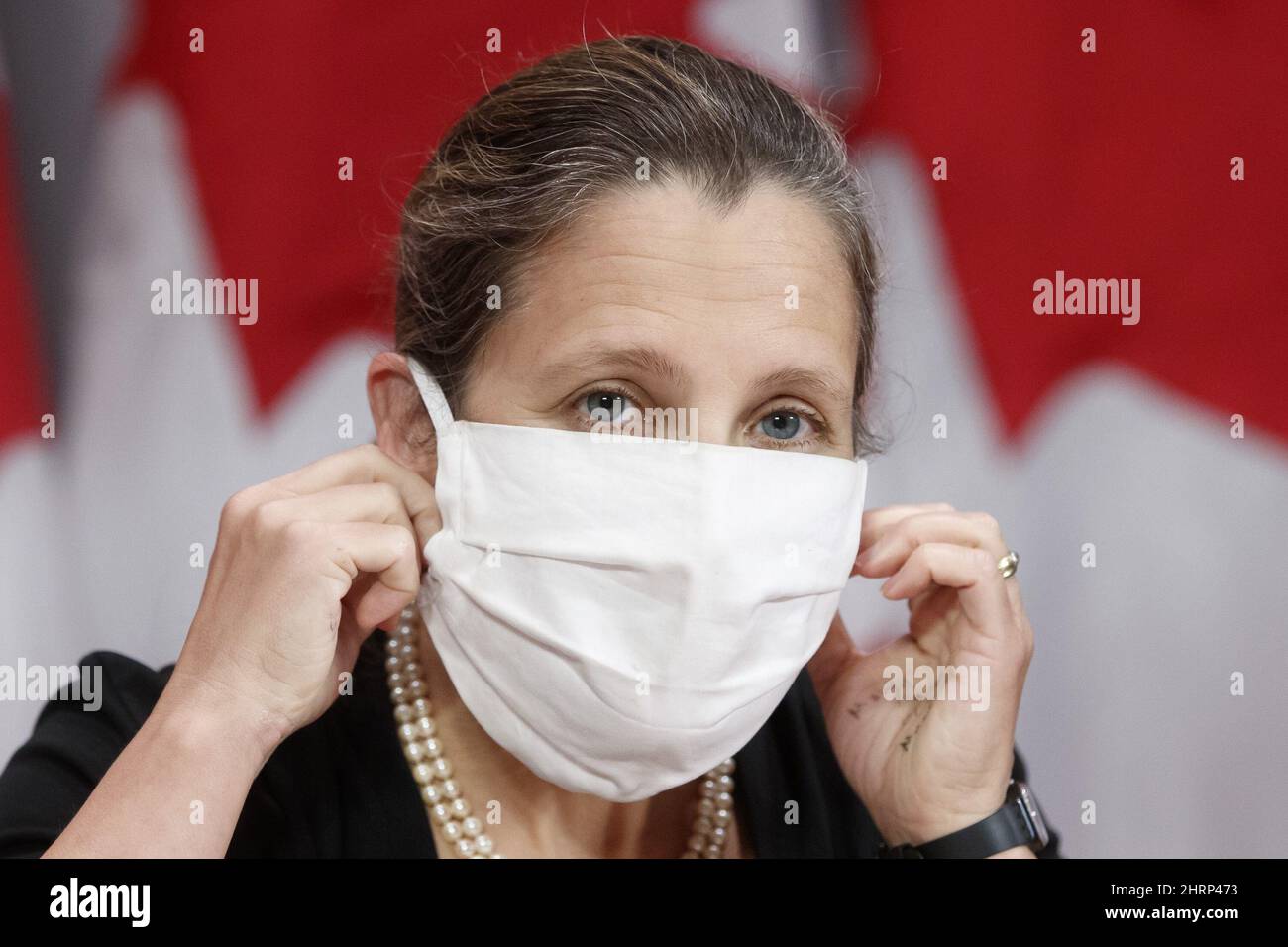 Deputy Prime Minister Chrystia Freeland removes her mask as she arrives ...