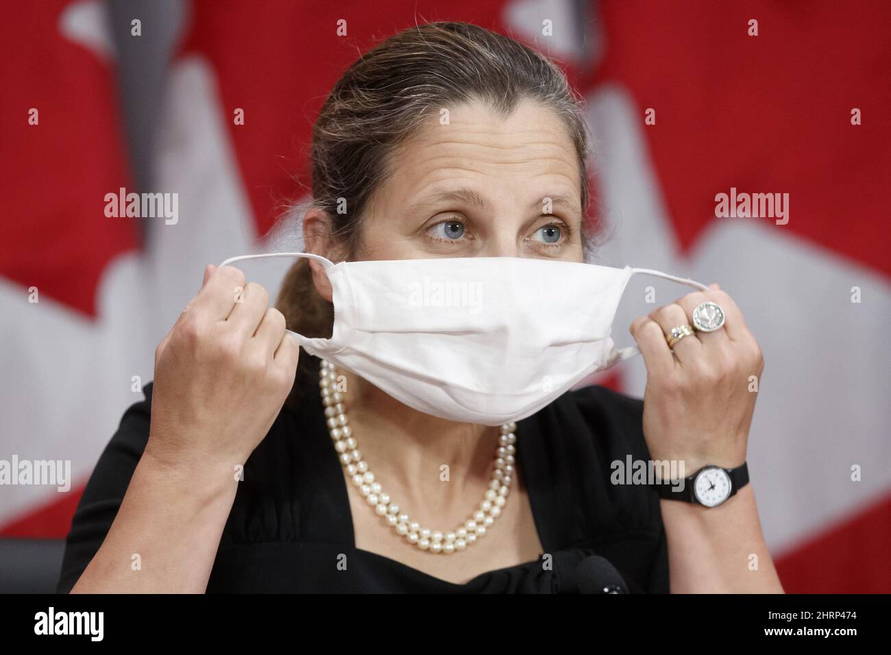 Deputy Prime Minister Chrystia Freeland removes her mask as she arrives ...