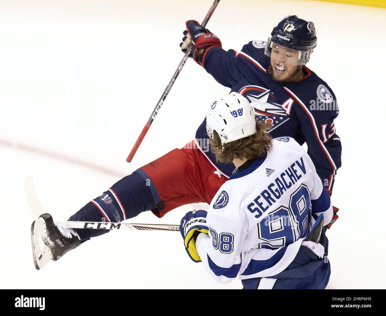 Columbus Blue Jackets right wing Cam Atkinson (13) gets bumped by Tampa ...