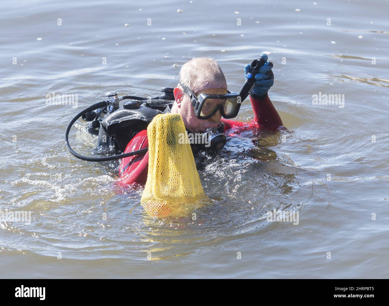 A diver searches for trash in the St. Lawrence River in Montreal ...