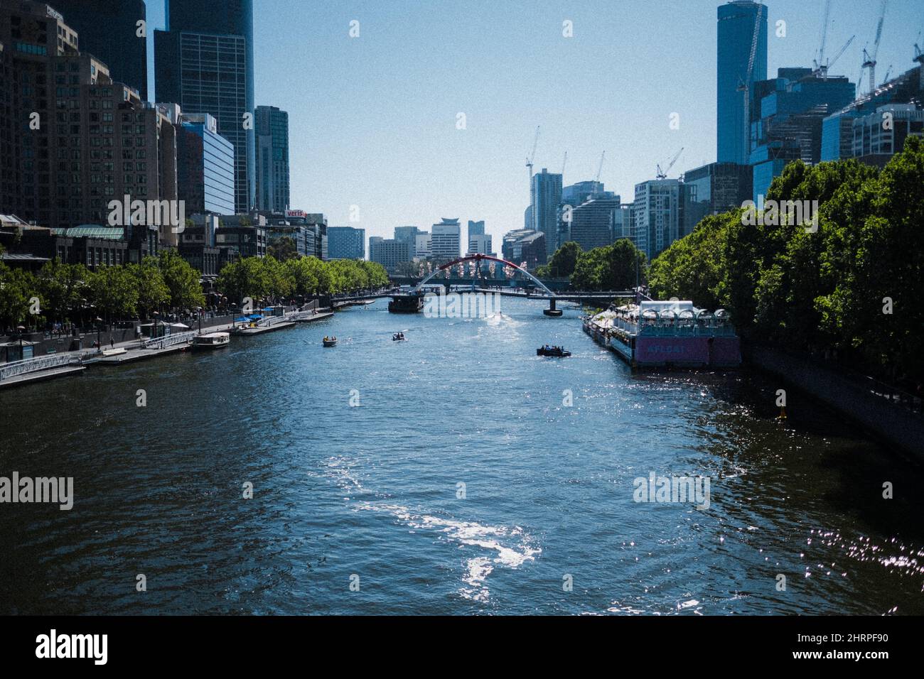 Scenery of a river flowing in the center of the city surrounded by tall ...