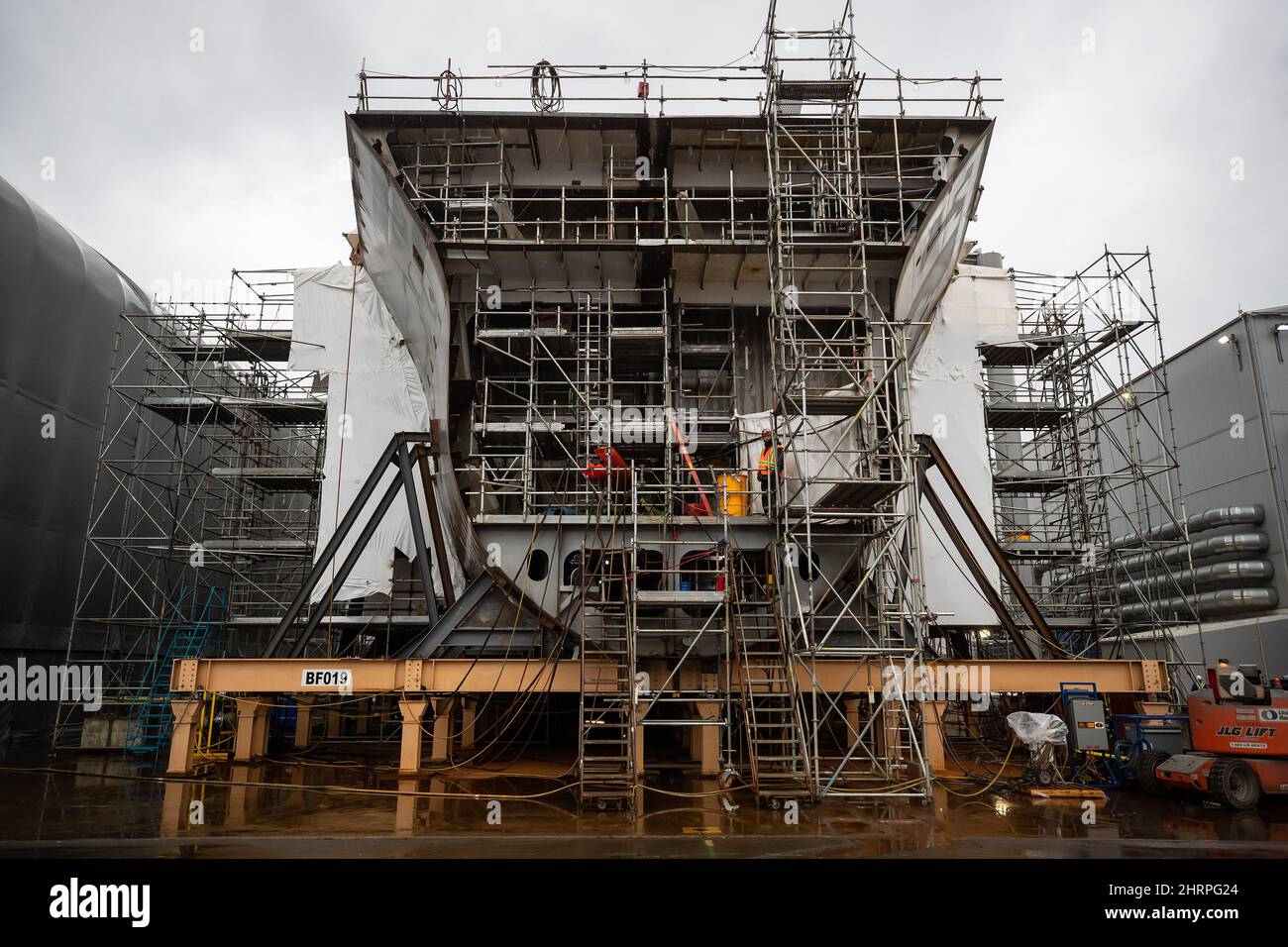 A worker stands on a Joint Support Ship being built for the Royal ...