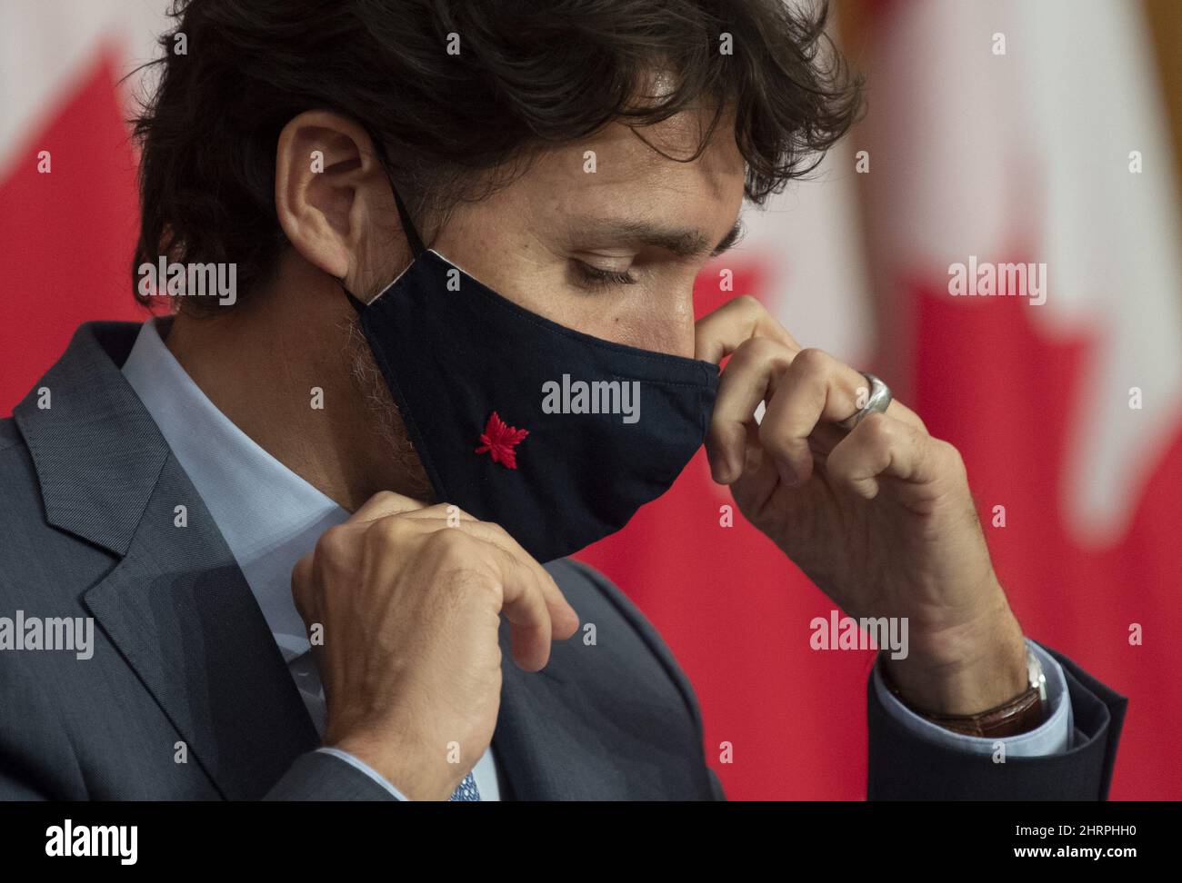 Prime Minister Justin Trudeau adjusts his mask as he leaves a news ...