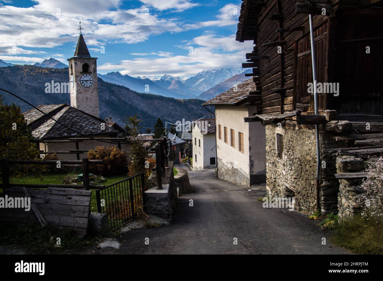 Scenic view of antique stone buildings surrounded by mountains in Val D ...