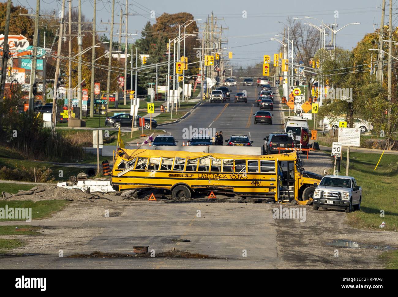 A truck makes it's way around a destroyed school bus blocking a main ...