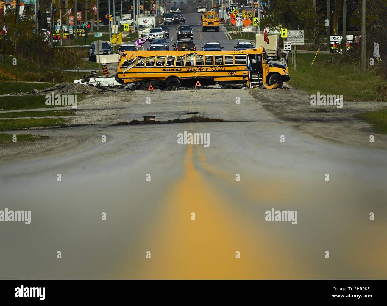 A school bus blocks the roadway which is near a construction site at ...
