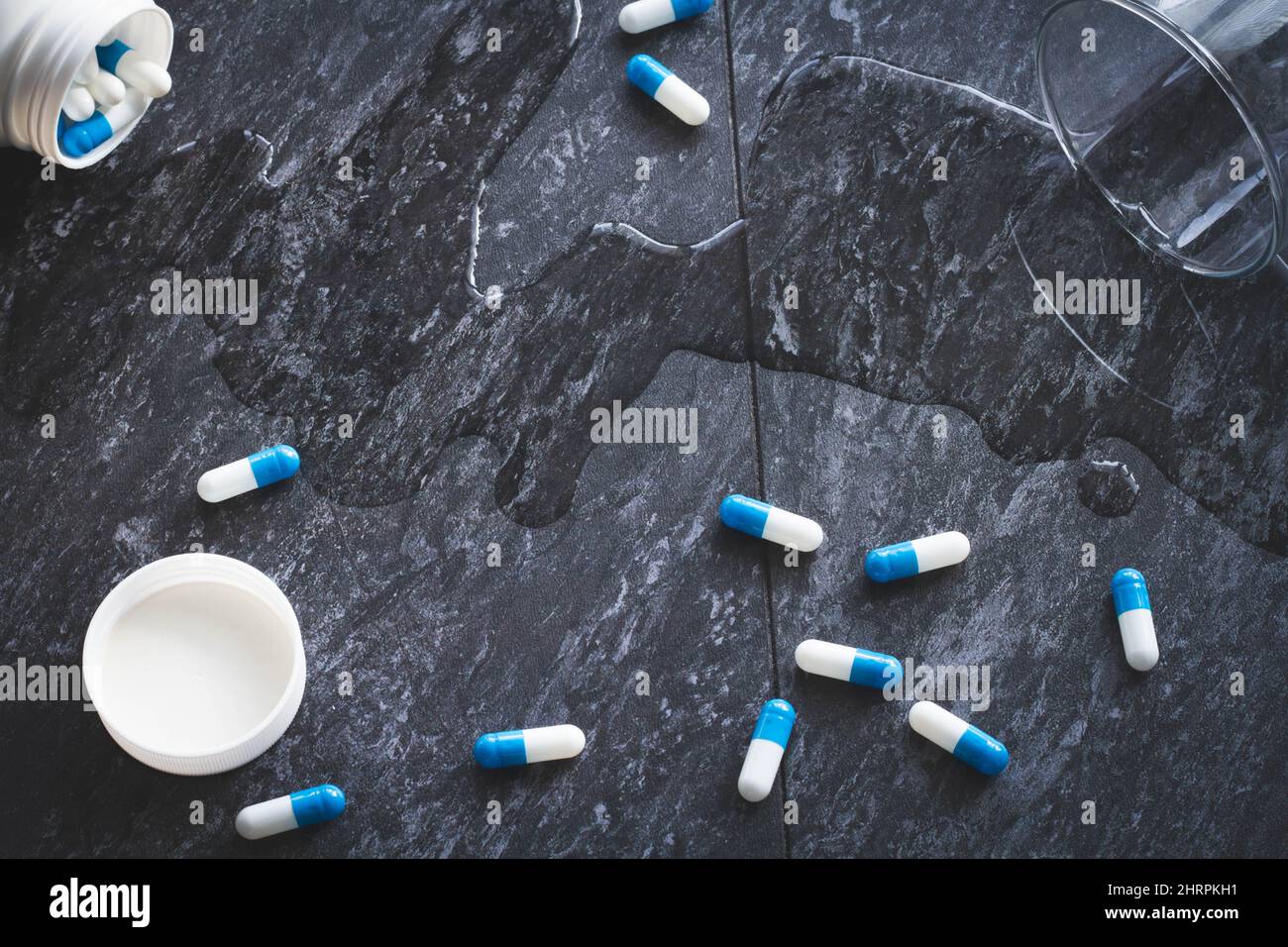 Tablets. Water is spilled and medical capsules are scattered. Ambulance ...