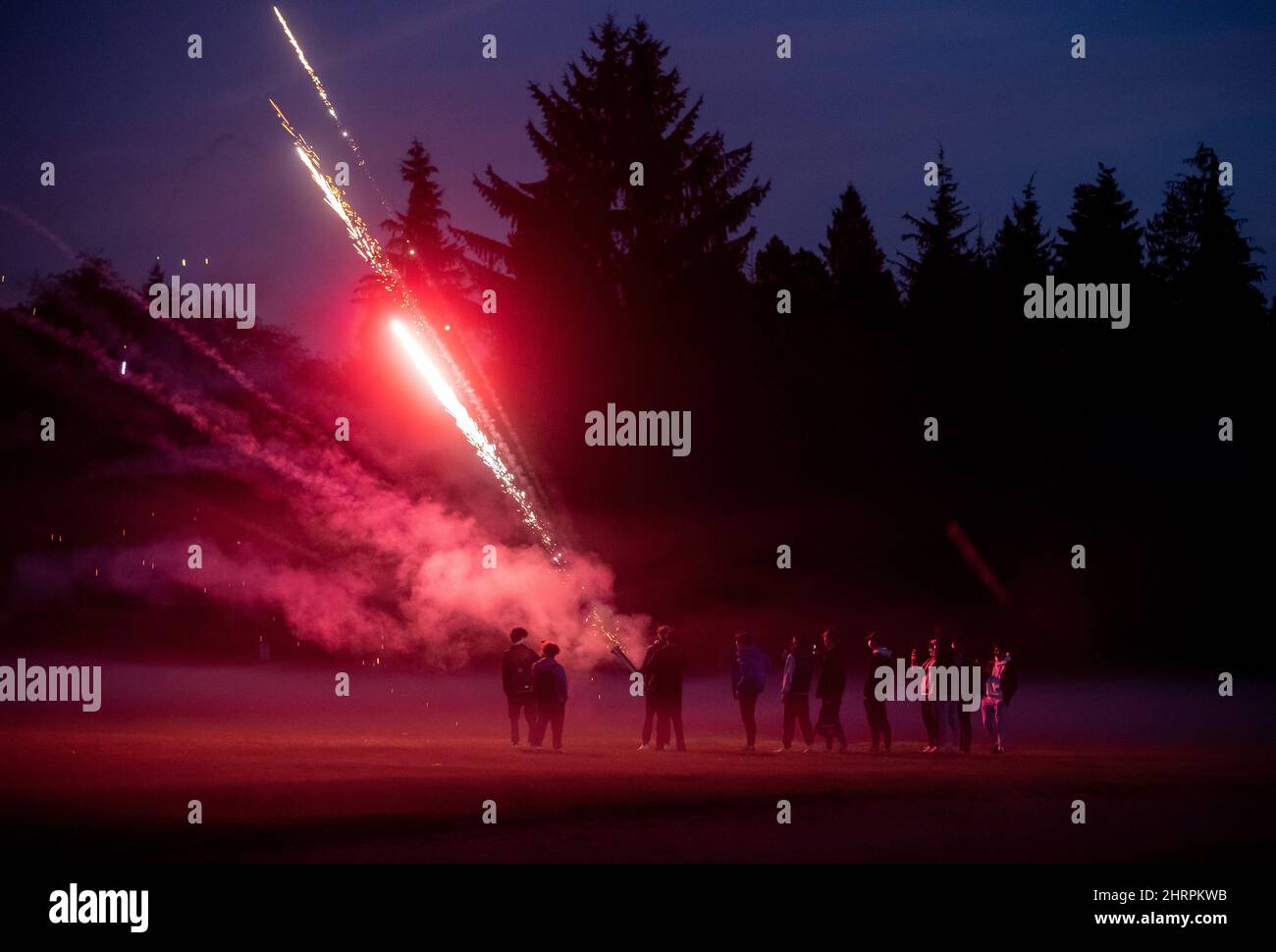 A group of young men shoot off fireworks on Halloween in Vancouver, on ...